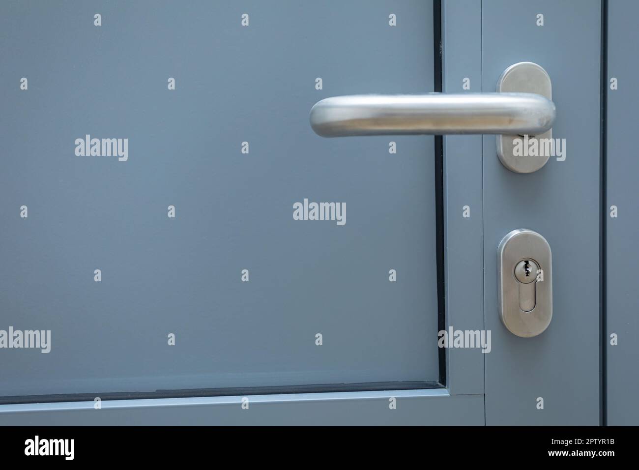 Metal handle and aluminum door with lock insert Stock Photo - Alamy