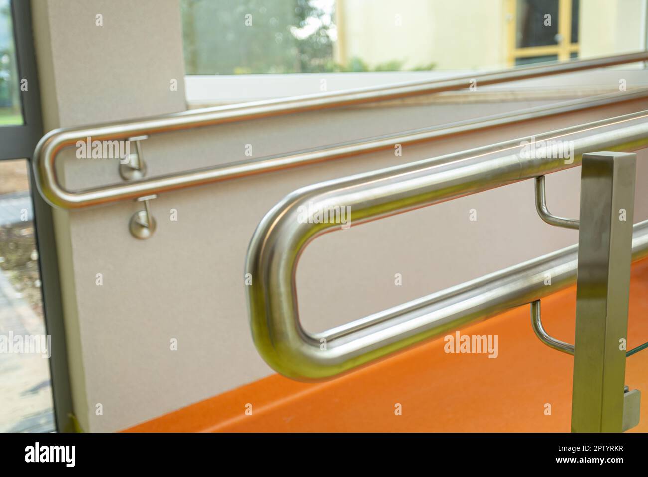 Stainless steel handle mounted to the wall in the hallway Stock Photo ...