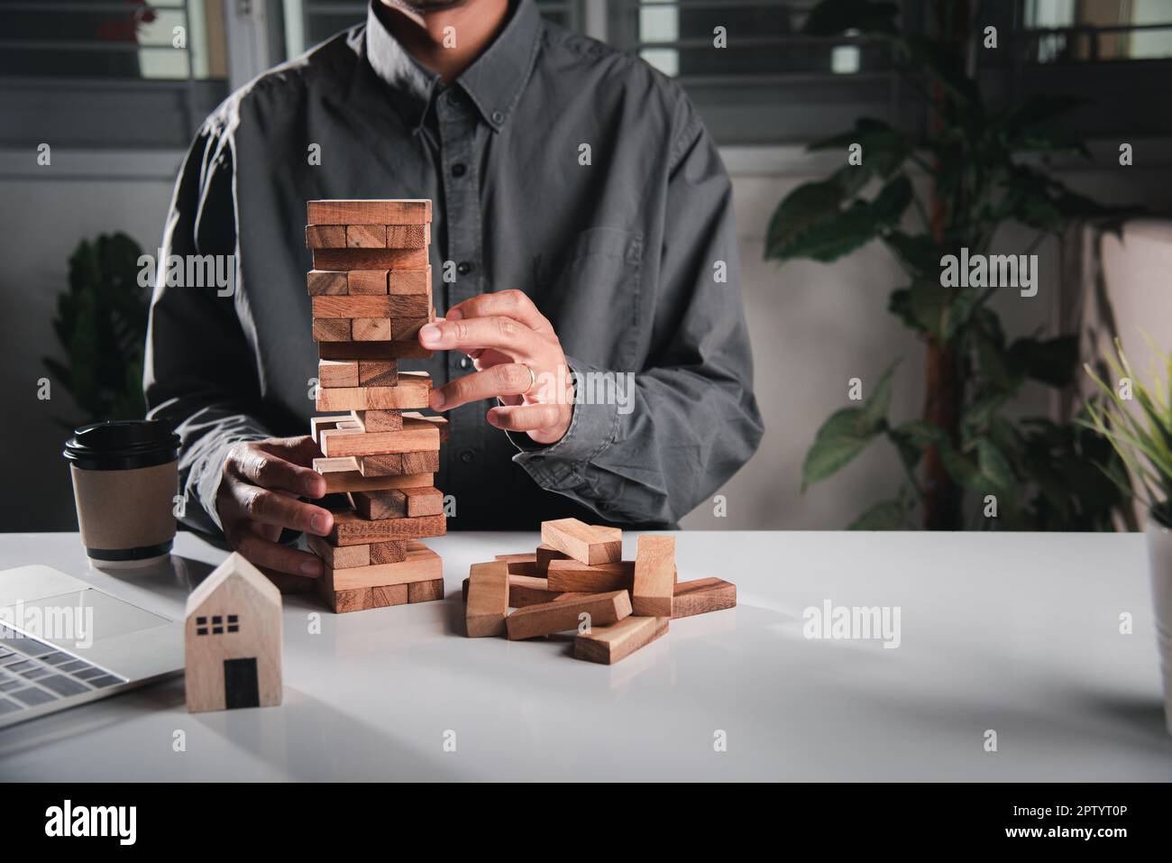 Alternative risk plan. Business hand playing tower wooden blocks game ...