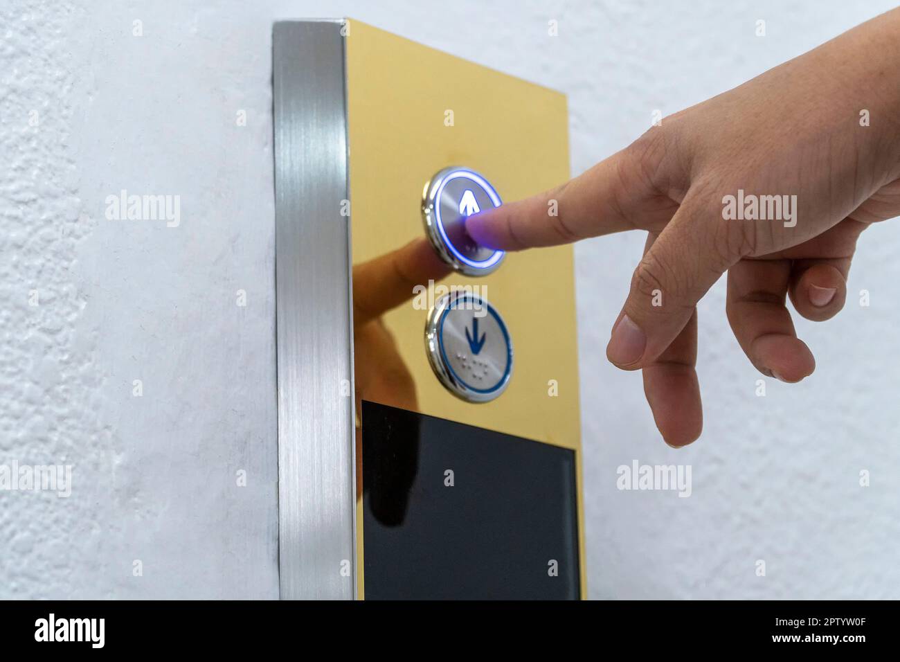 Hand push the elevator button up Stock Photo - Alamy