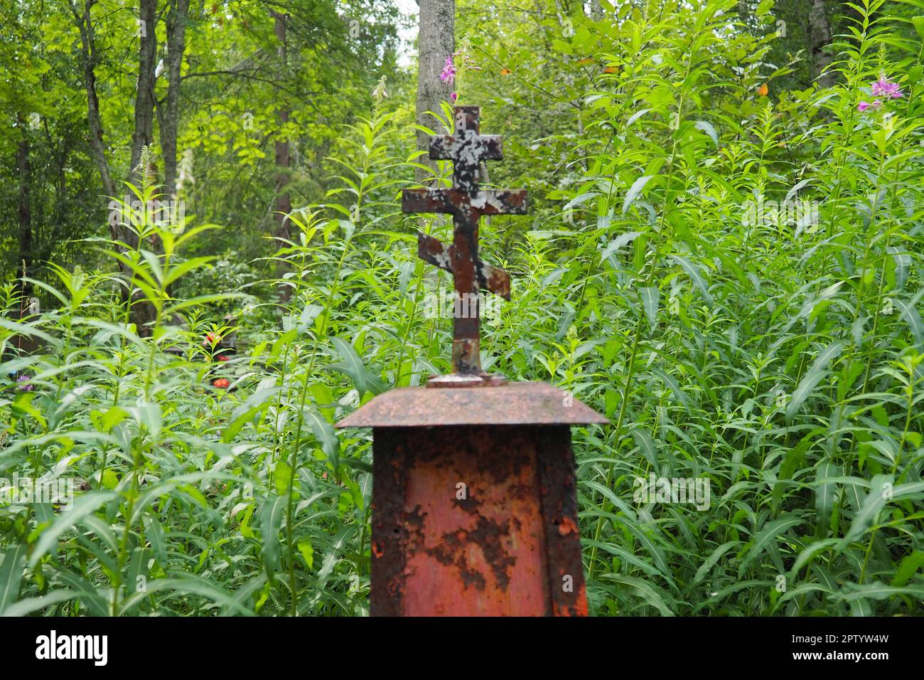 Metal cross on the grave. Monument in the form of a cross in the ...