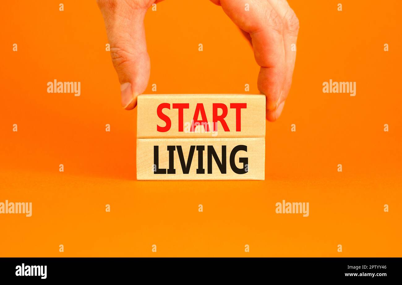 Start living symbol. Concept words Start living on beautiful wooden ...