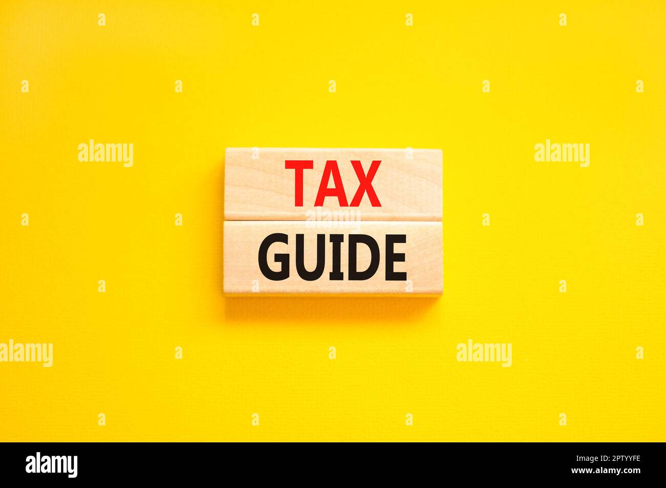 Tax guide symbol. Concept words Tax guide on beautiful wooden block ...