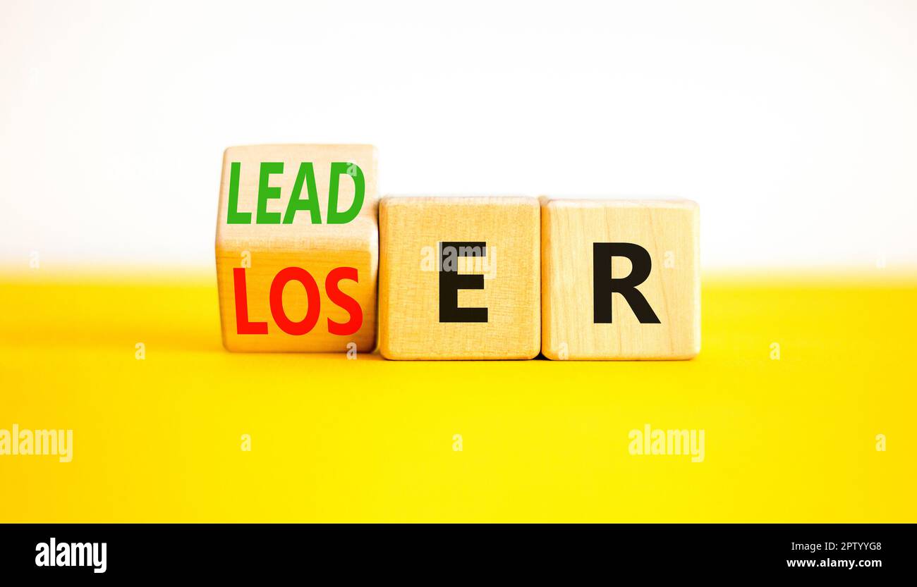 Loser or leader symbol. Businessman turns wooden cubes and changes the ...