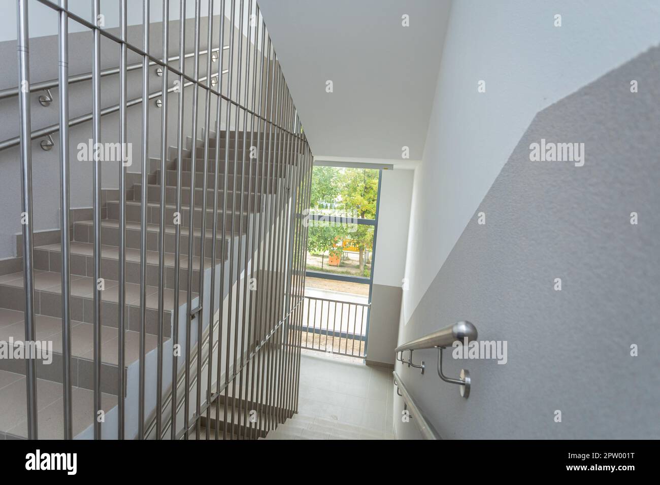 Staircase with stainless steel bar protection installed Stock Photo - Alamy