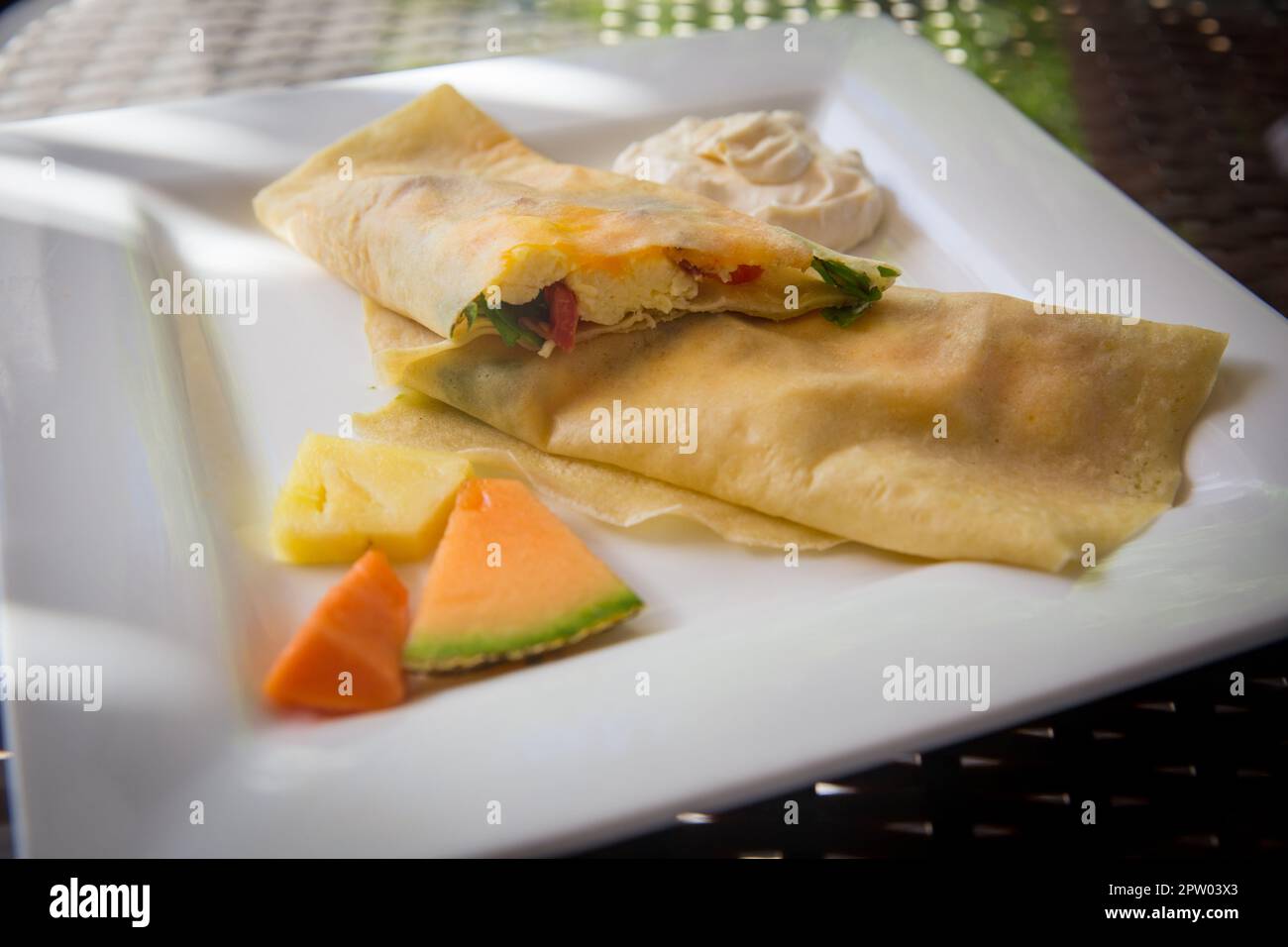 Sliced Stuffed Breakfast Crepe with eggs, Spinach and Cheese Stock ...