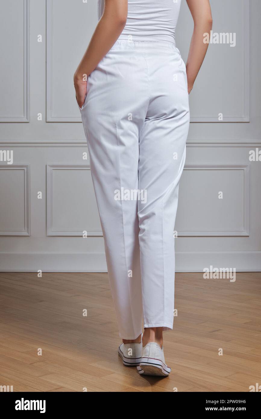 Female legs in medical pants and white sneakers. Medical uniform Stock ...