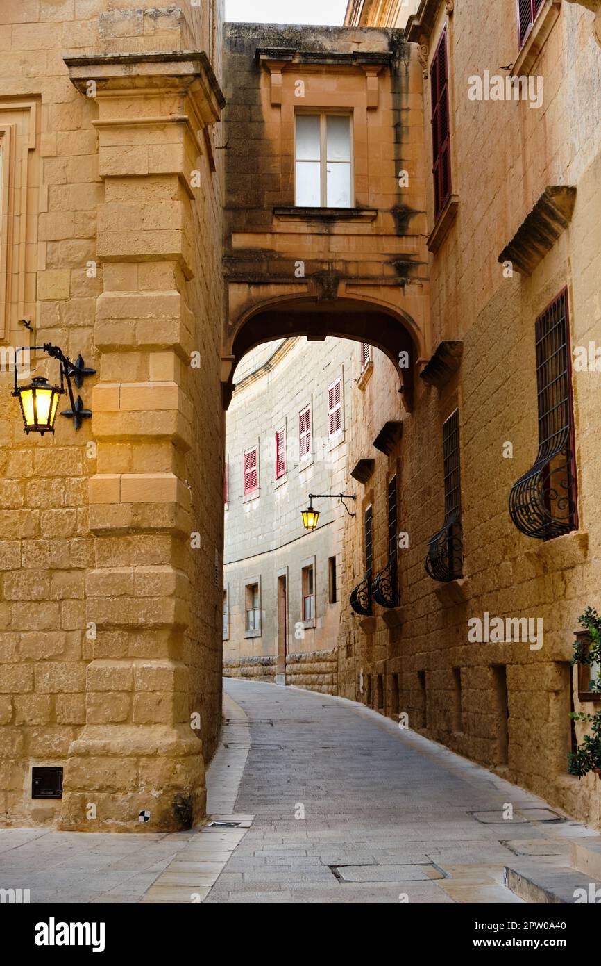 A narrow winding street with an arched passageway - Mdina, Malta Stock ...