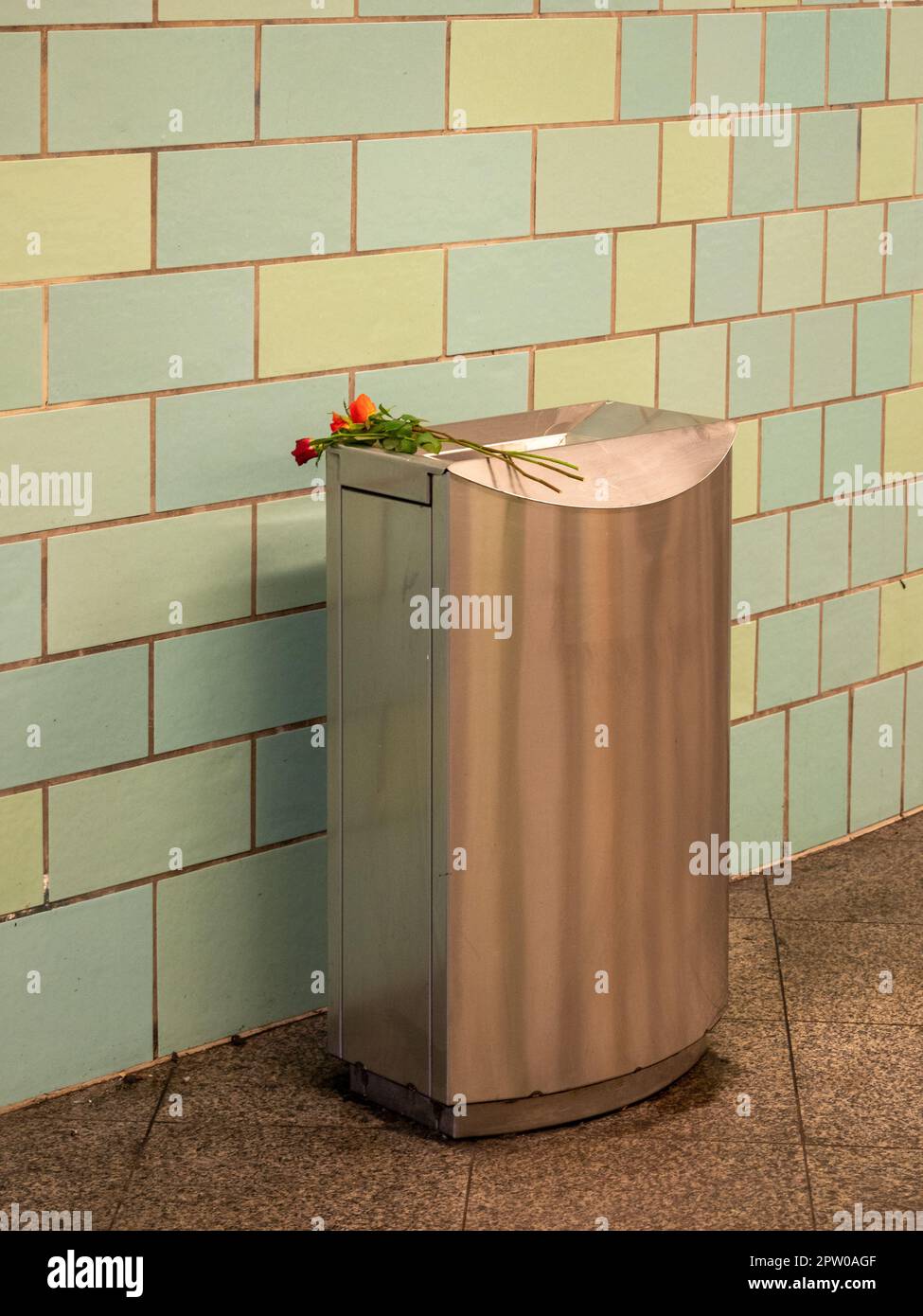 A bouquet of flowers in a trash can. Trash can in the underpass Stock ...