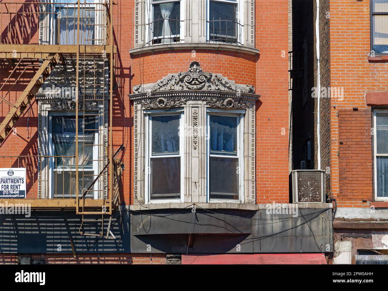 Ornate terra cotta spandrels and window surrounds grace this red-brick ...