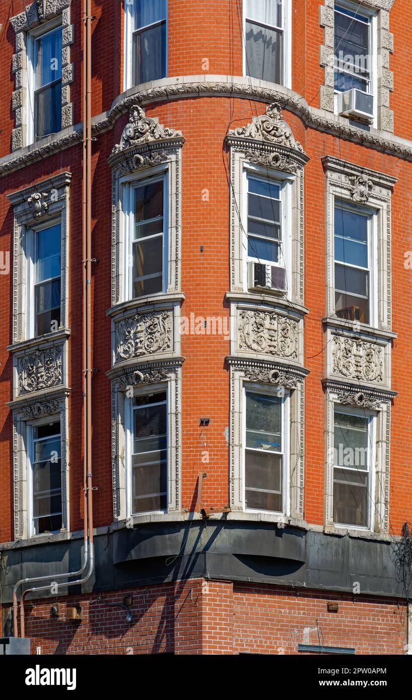 Ornate terra cotta spandrels and window surrounds grace this red-brick ...