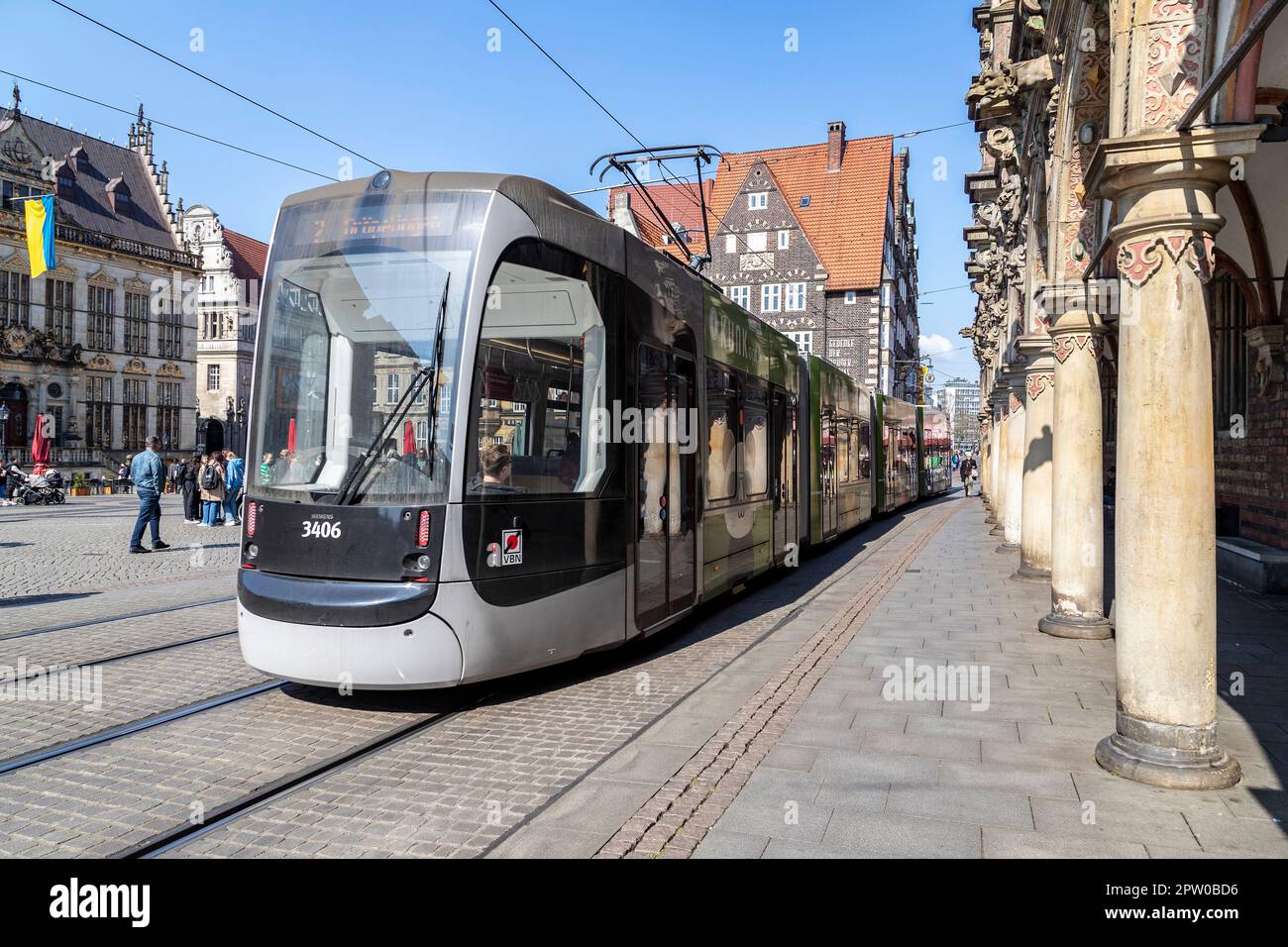 Tram going alongside The Townhall on the edge of the market square in ...