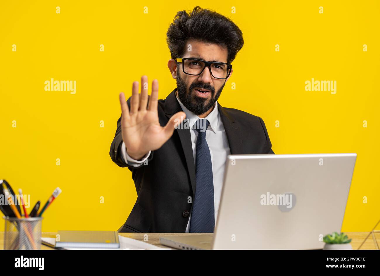 Stop. Indian businessman guy working on laptop, warning of finish ...