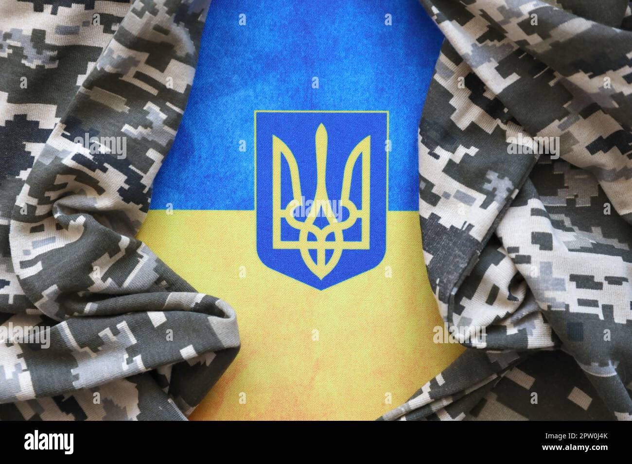 Ukrainian flag and coat of arms with fabric with texture of pixeled ...