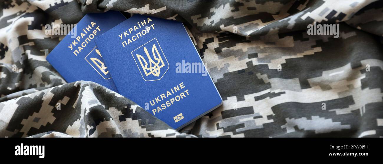 Ukrainian foreign passport on fabric with texture of military pixeled ...