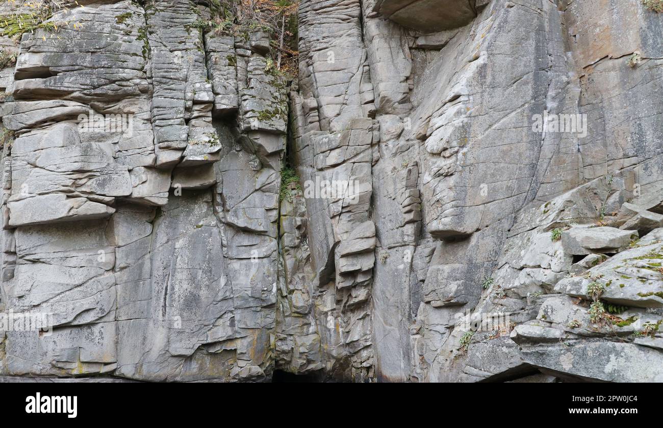 Light coarse natural rock stone background. Mining cliff rough front surface. Big limestone ...