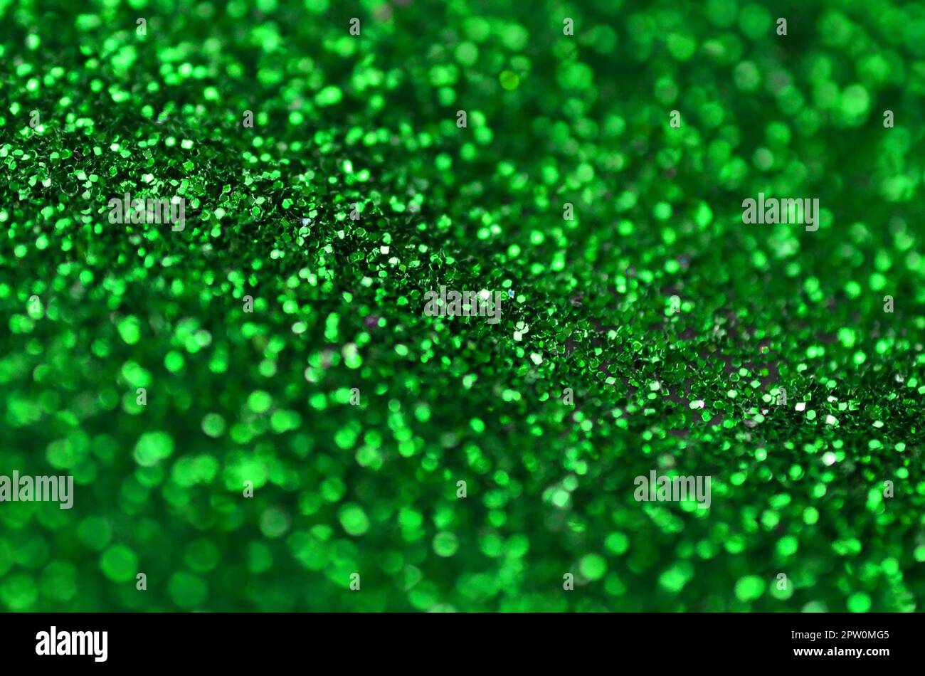 A huge amount of green decorative sequins. Background image with shiny ...