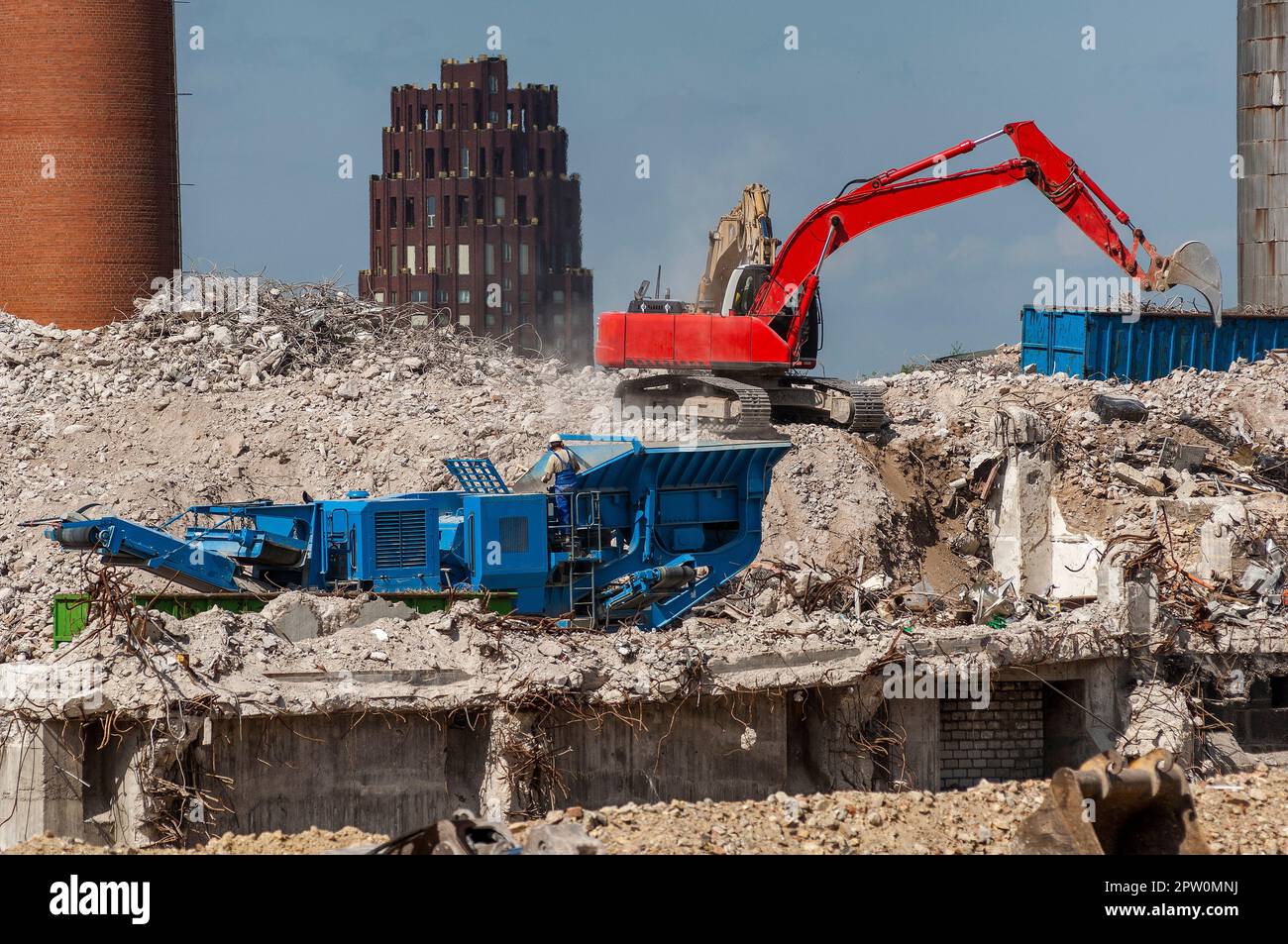 The demolition of a building with heavy equipment in the midst of ...