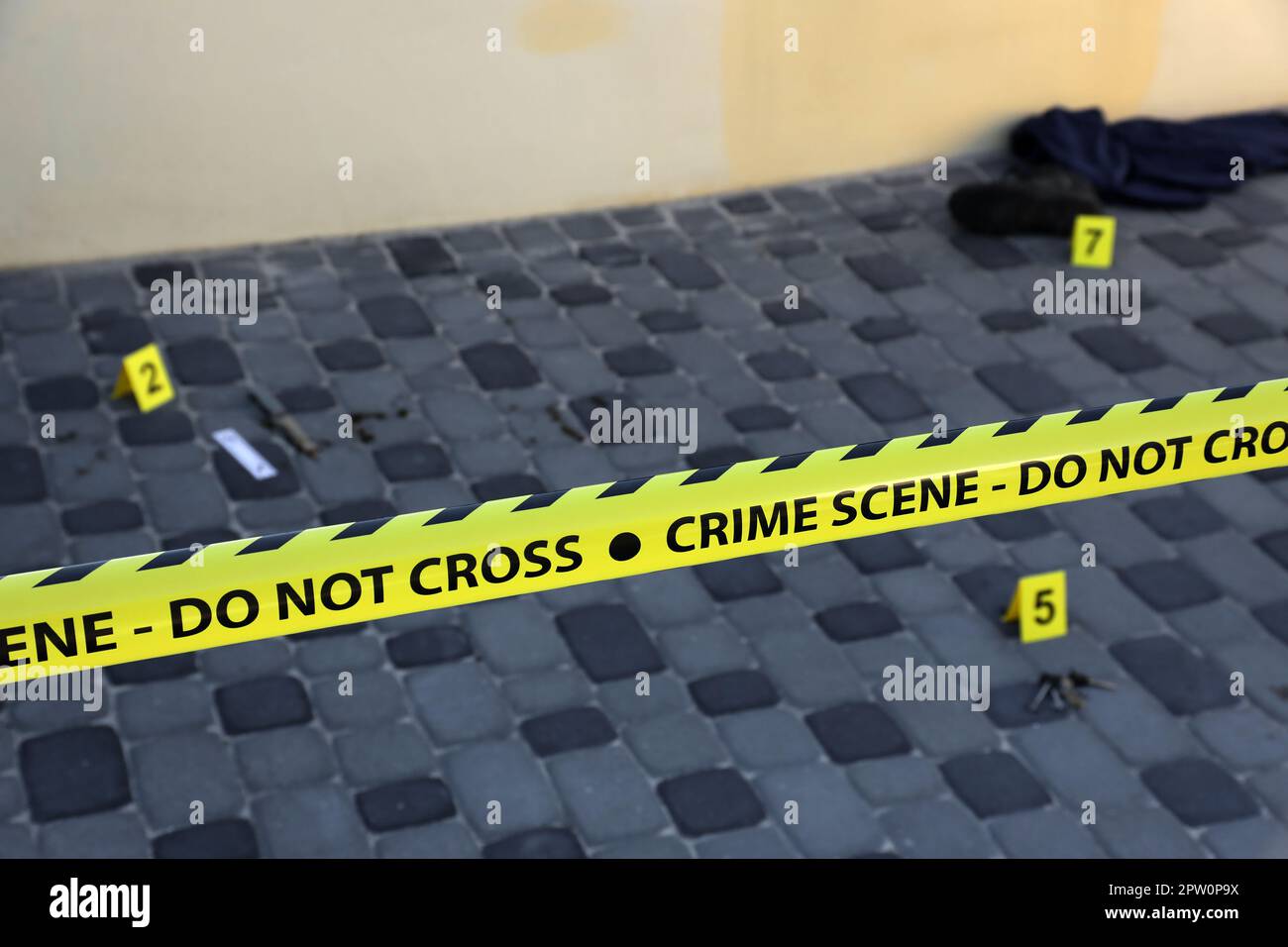Crime scene tape for covering the area cordon. Yellow tape with blurred ...