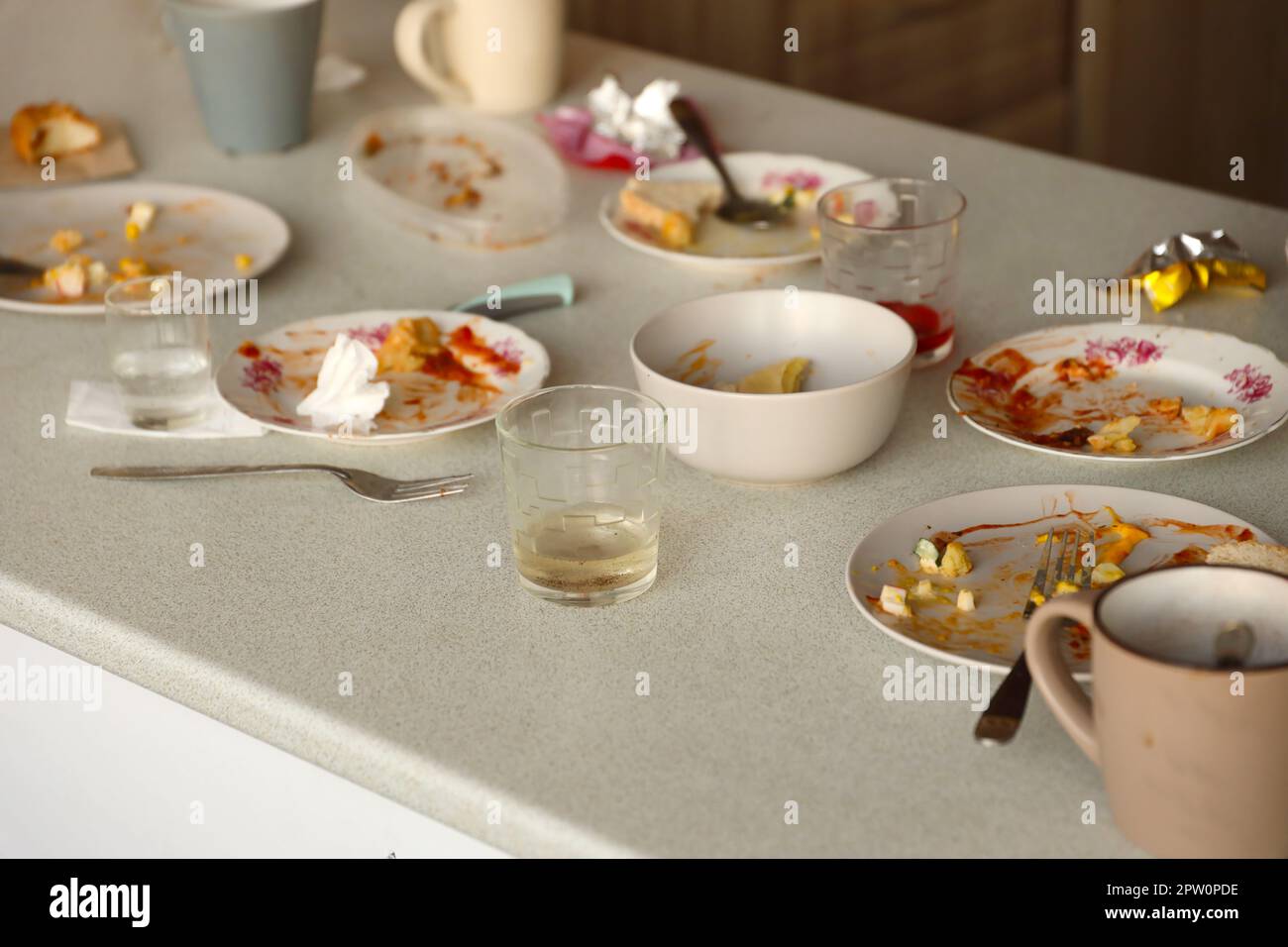 Empty dirty plates with spoons and forks on the table after meal ...