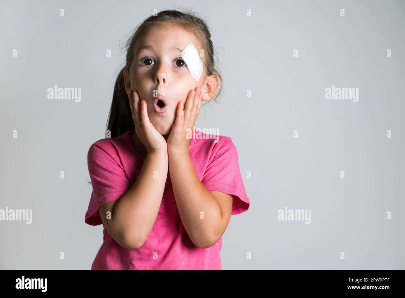 Close up surprised, shocked adorable dark haired child, girl with ...