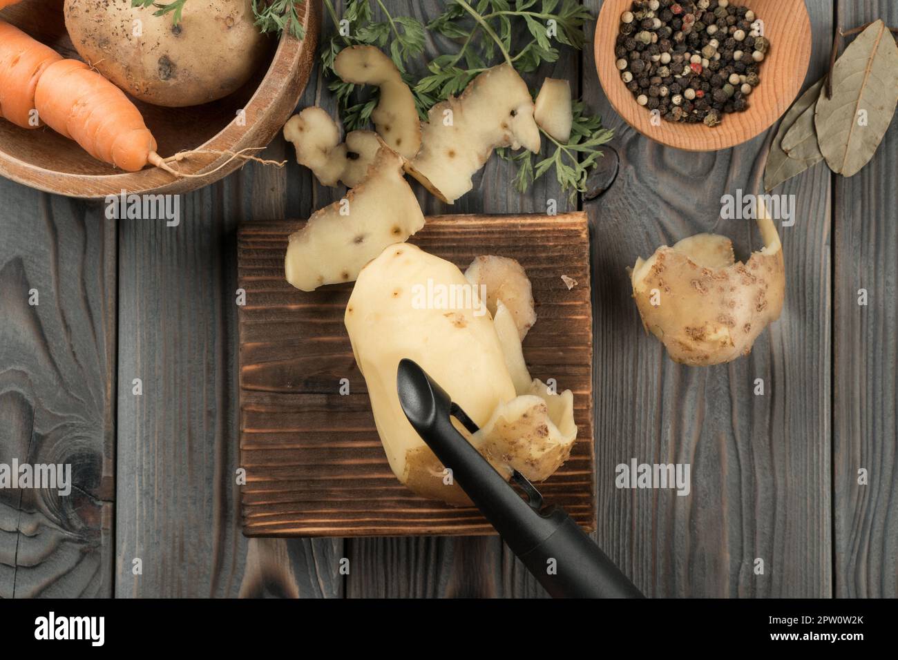 Peeling yellow potato with vegetable peeler. Flat lay view. Fresh raw ...