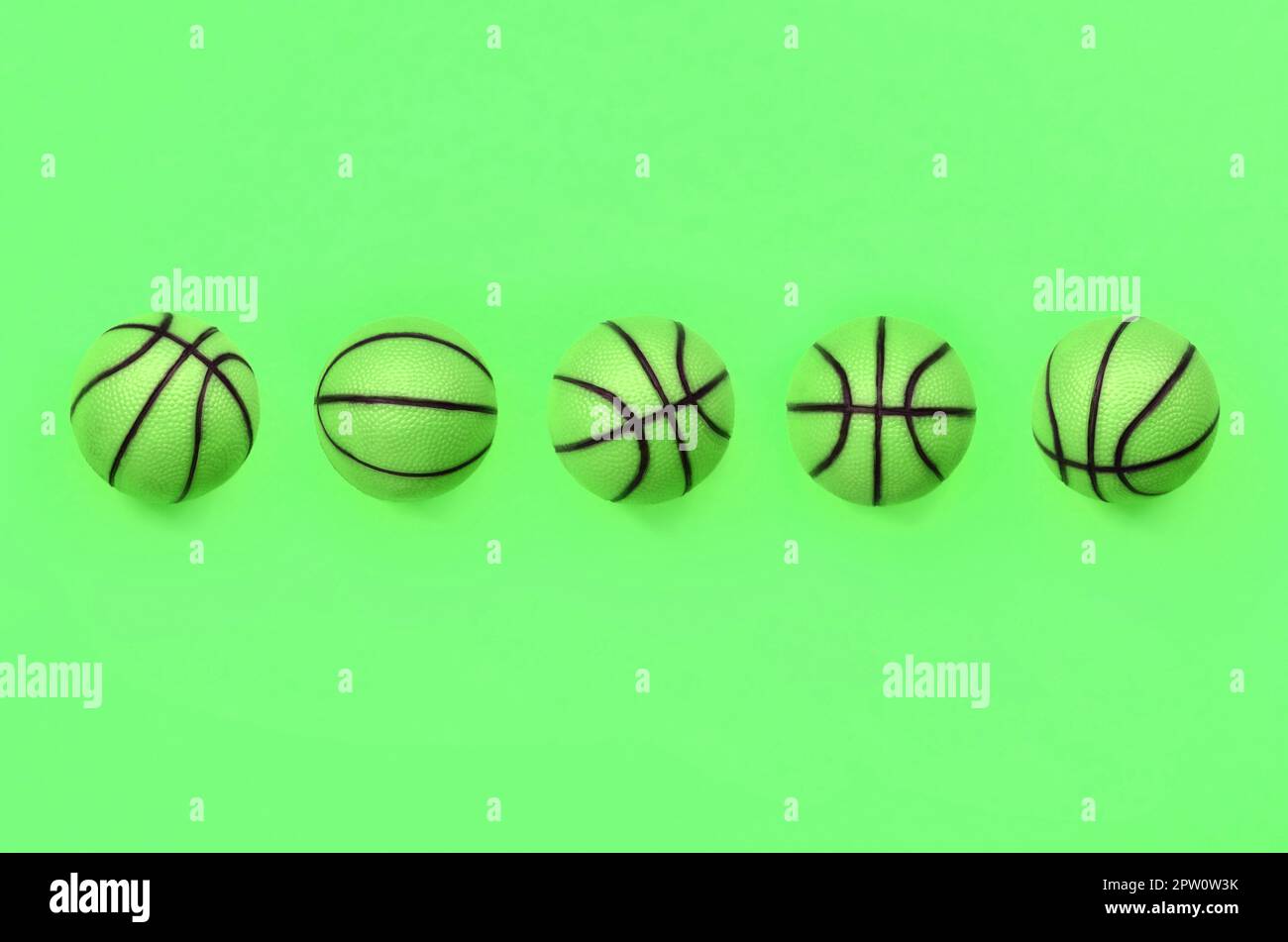 Many small green balls for basketball sport game lies on texture ...