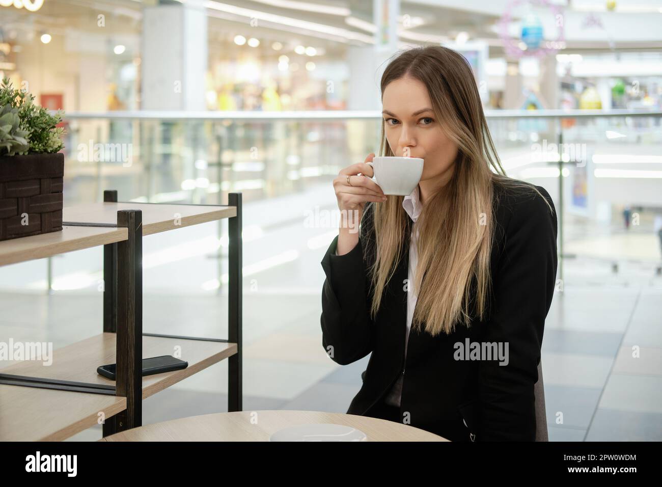 Beautiful girl office employee having coffee break in big mall Stock Photo - Alamy