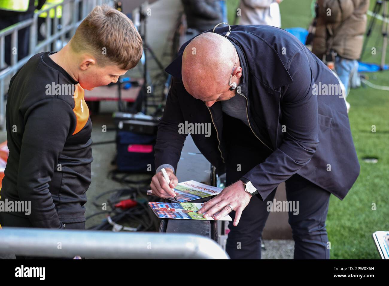 Former Blackpool player Charlie Adam signs a young fans program during ...