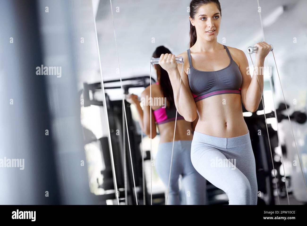 Tools of the fitness trade. A beautiful young woman doing weight-training at the gym Stock Photo ...