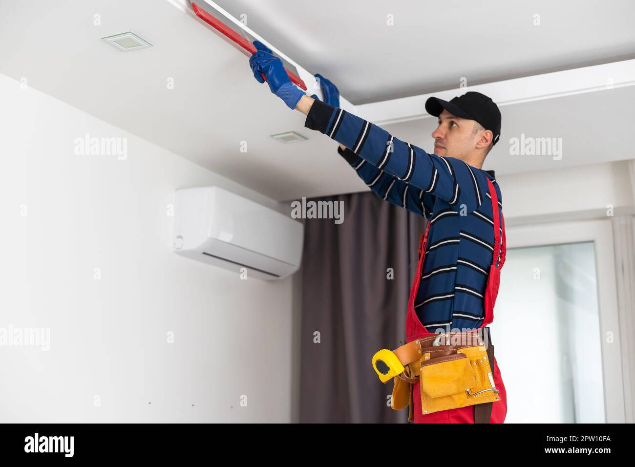 Construction worker installation ceiling work Stock Photo - Alamy