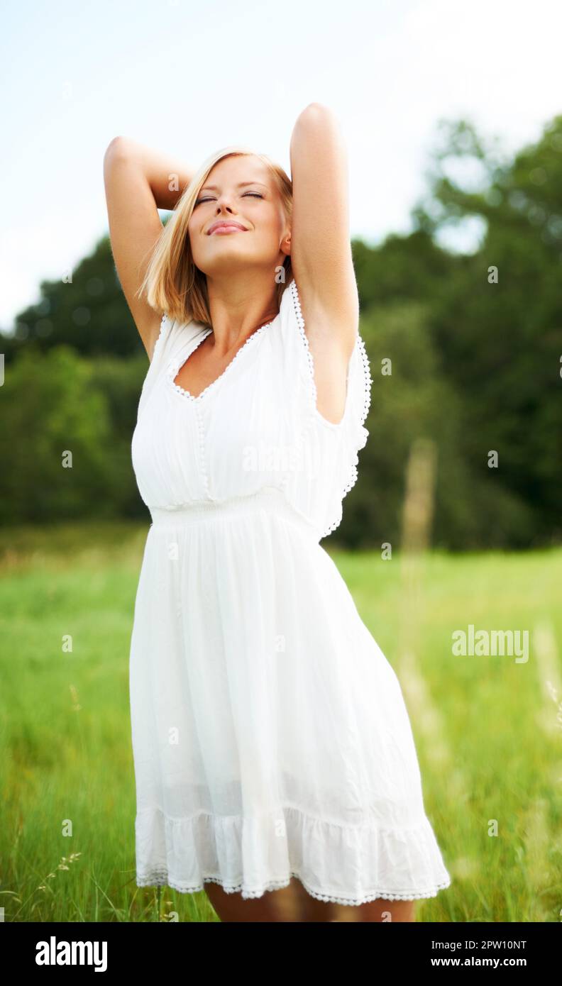 Luxuriating in the moment. Beautiful young woman standing outdoors ...