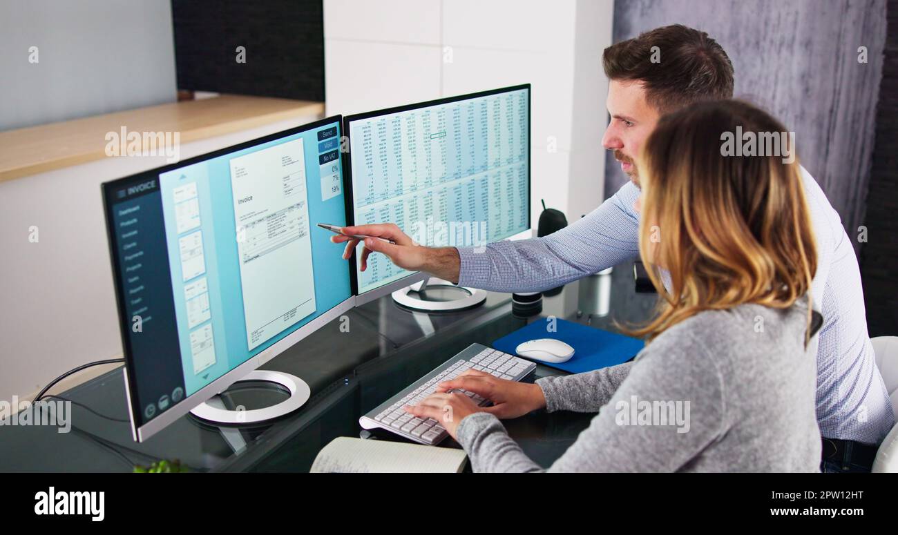 Spreadsheet And Electronic Invoice On Multiple Computer Screens Stock ...