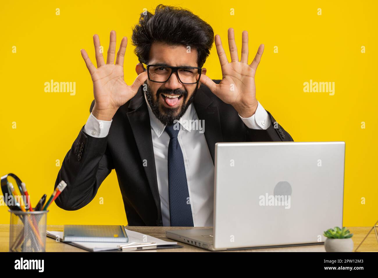 Indian businessman use laptop computer, making funny face, fooling ...