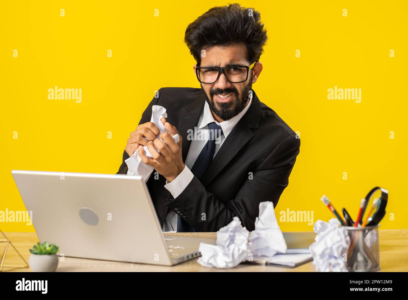 Angry furious indian man working at office throwing crumpled paper ...