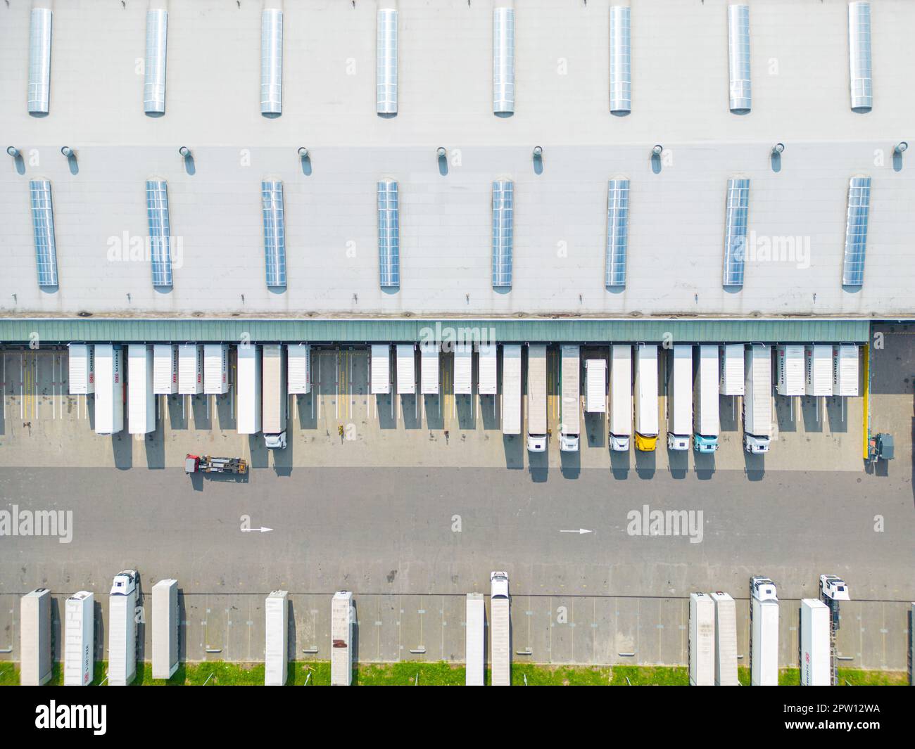 Logistics park with warehouse. Semi-trailers trucks standing on car ...