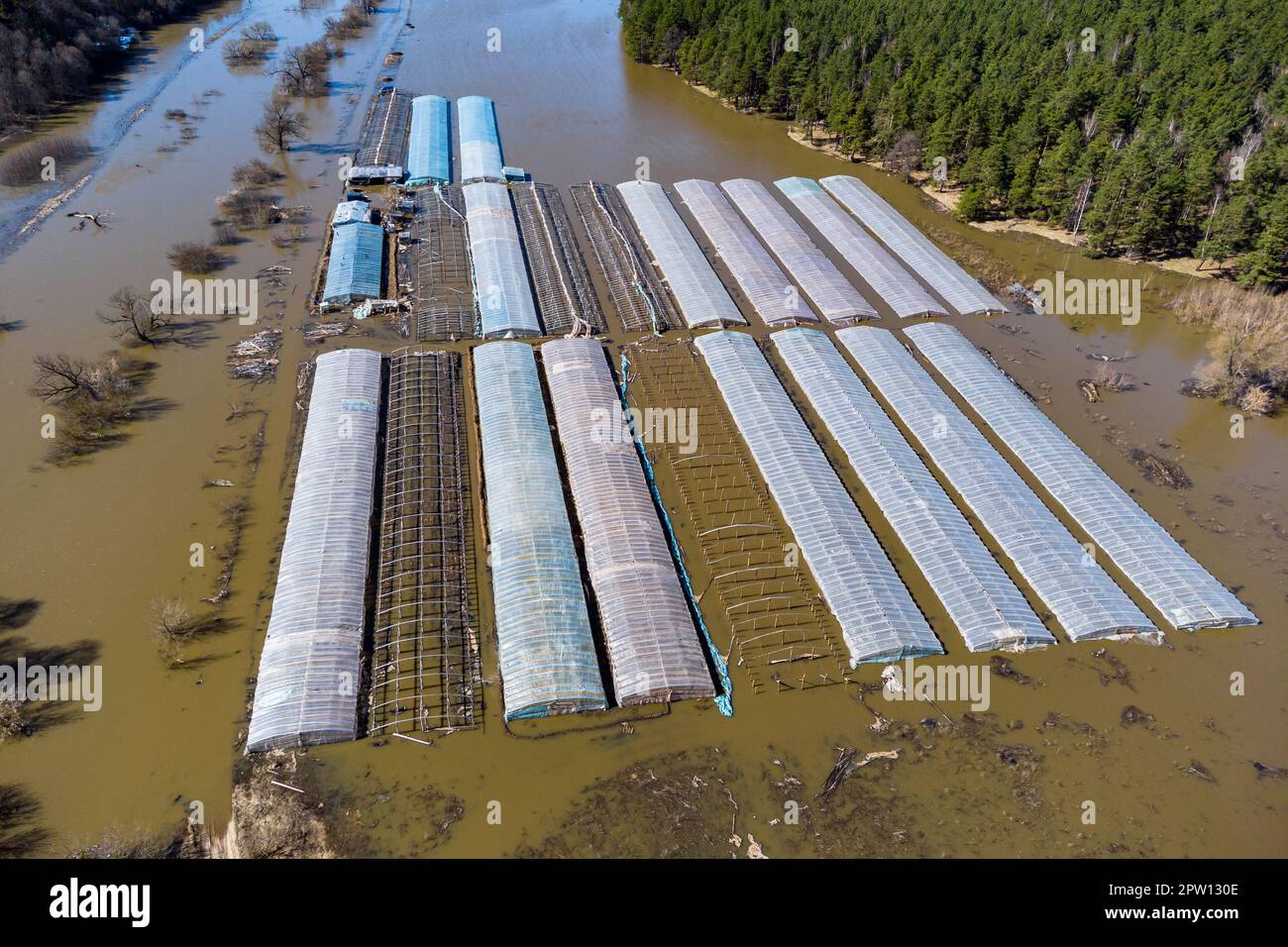 Farmlands and greenhouses flooded during the spring flood in the river ...