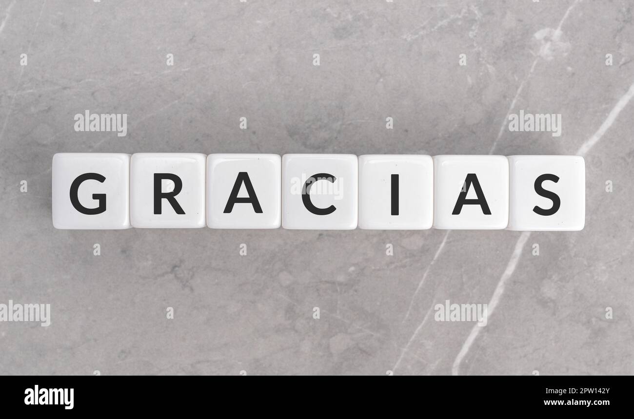 Thank you phrase on spanish language white blocks on gray marble ...