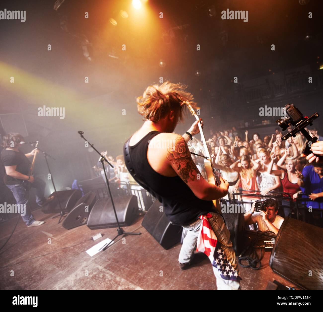 Rock, music festival and band guitar performance with crowd, fans and ...