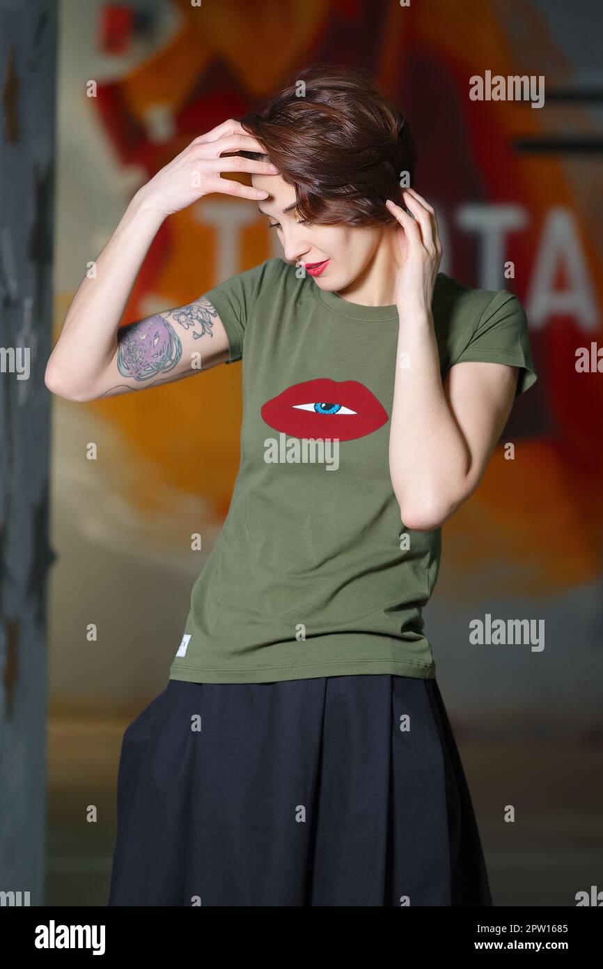 Tricky funny girl posing in blue fleece sweatshot and playing with her ...