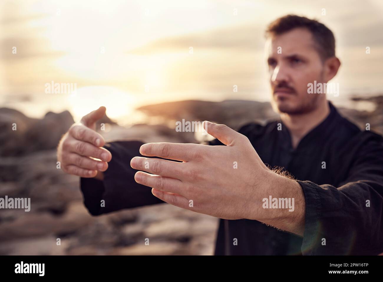 Man, hands and tai chi on sunset beach in relax workout, fitness or ...