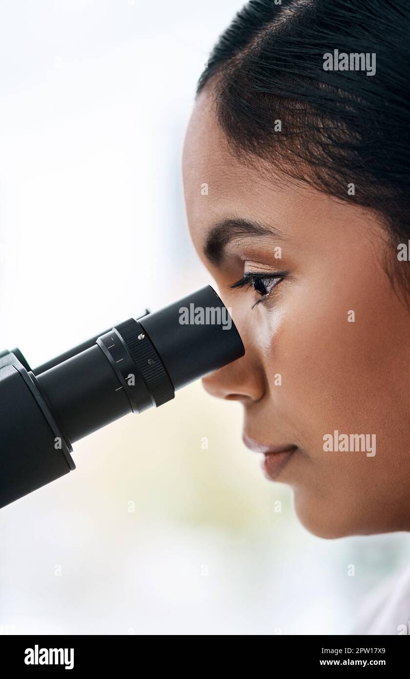 Closeup woman looking through microscope hi-res stock photography and ...