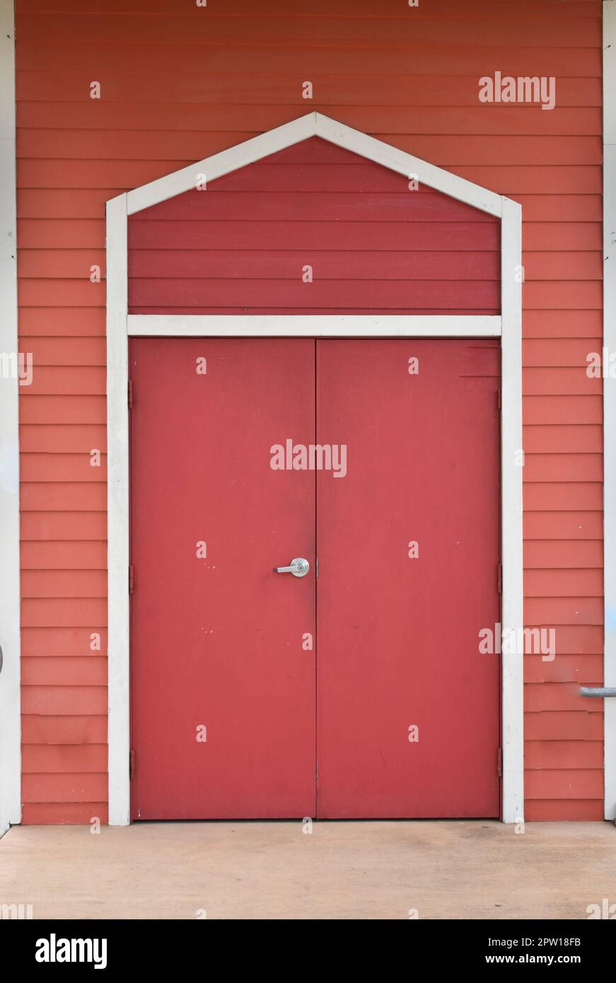 Colorful orange siding red exterior doors Stock Photo - Alamy