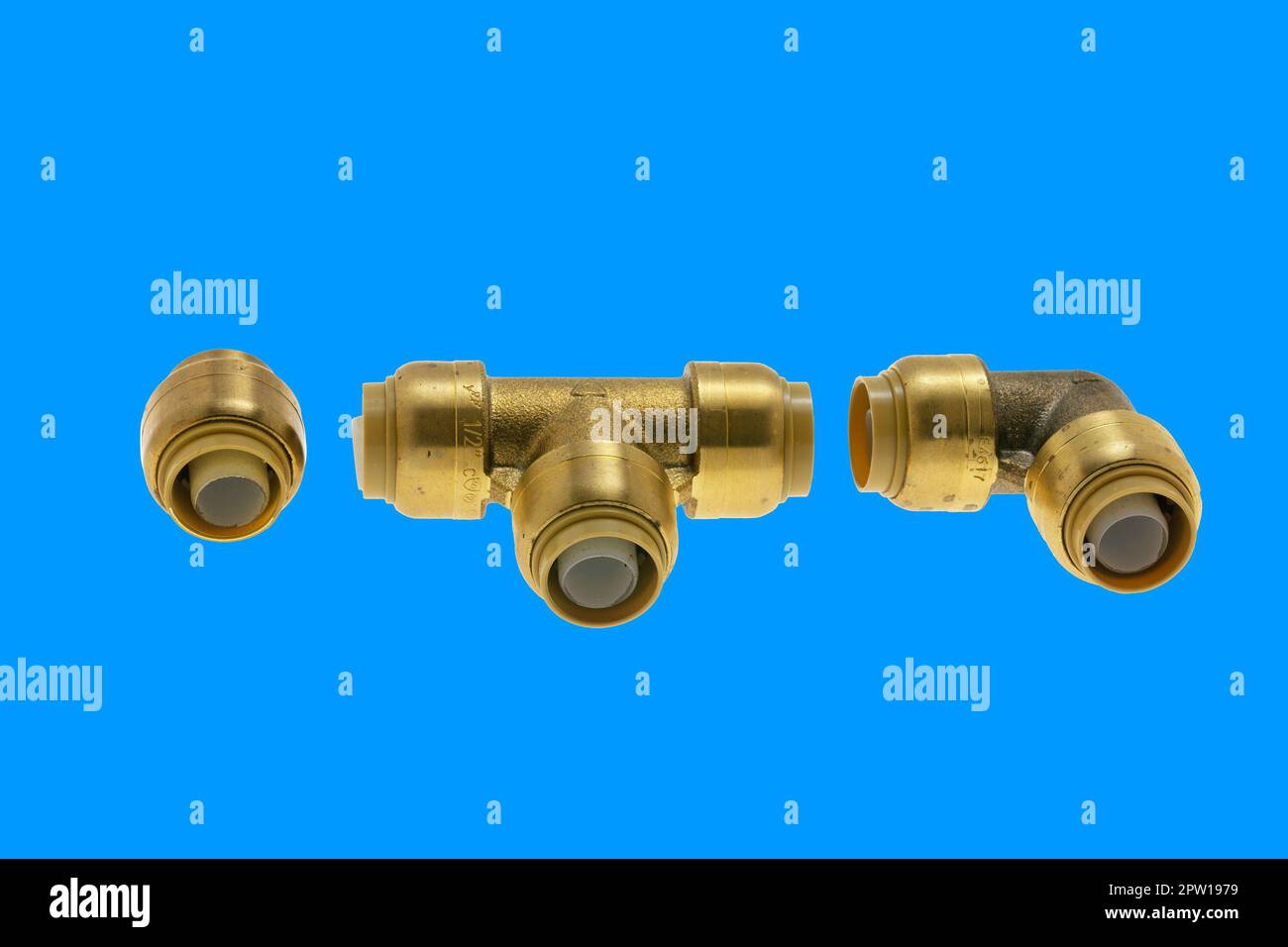 Bronze angle fittings for the work of a plumber on a blue background ...