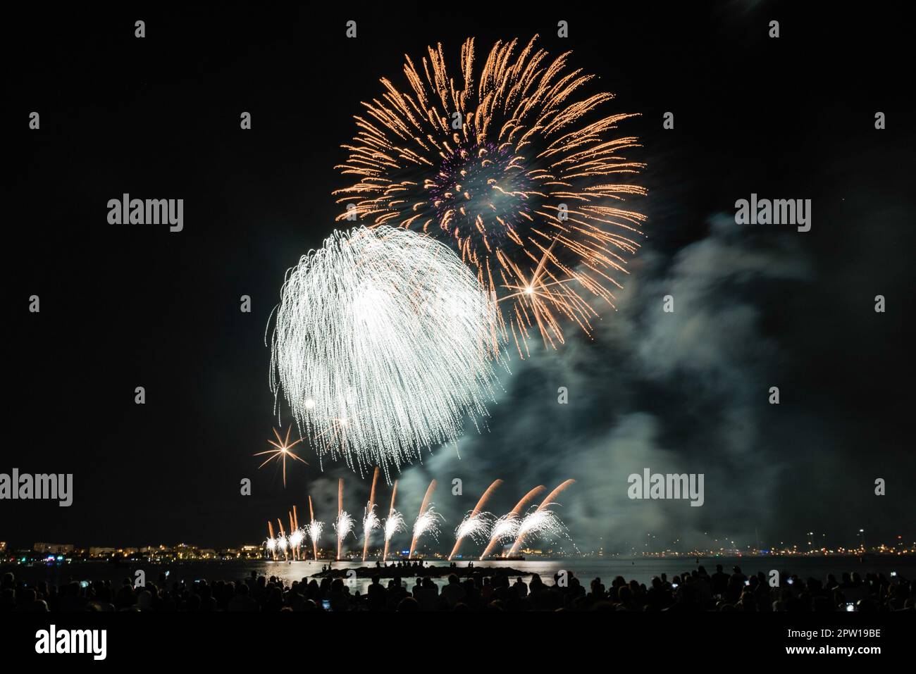 Scenic fireworks glowing in the night for the 14th of July celebrations ...