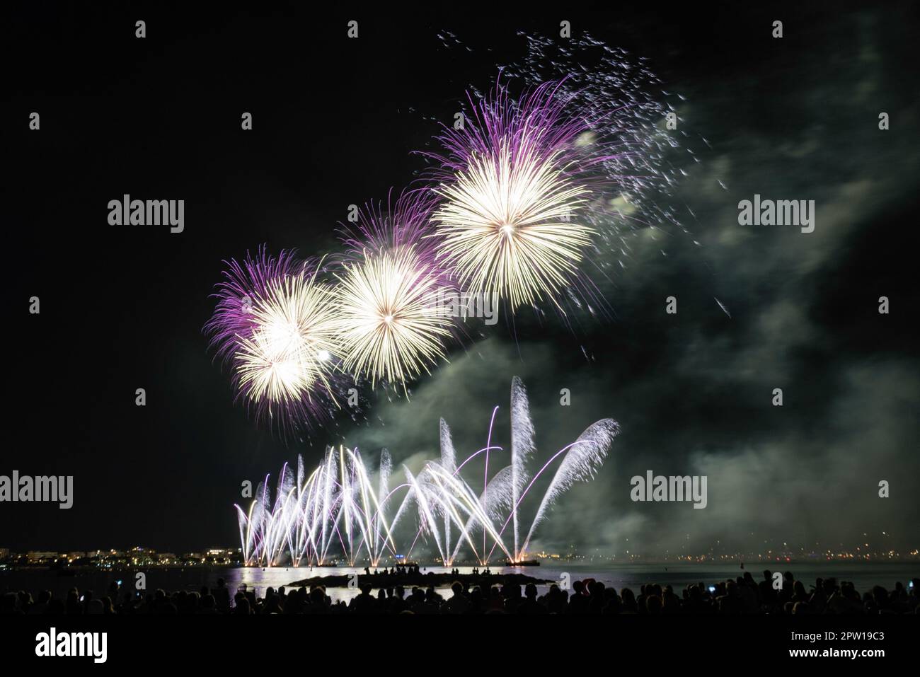 Scenic fireworks glowing in the night for the 14th of July celebrations ...