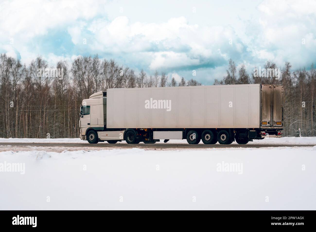 Road transport of goods by truck.Truck driving on the winter road in ...