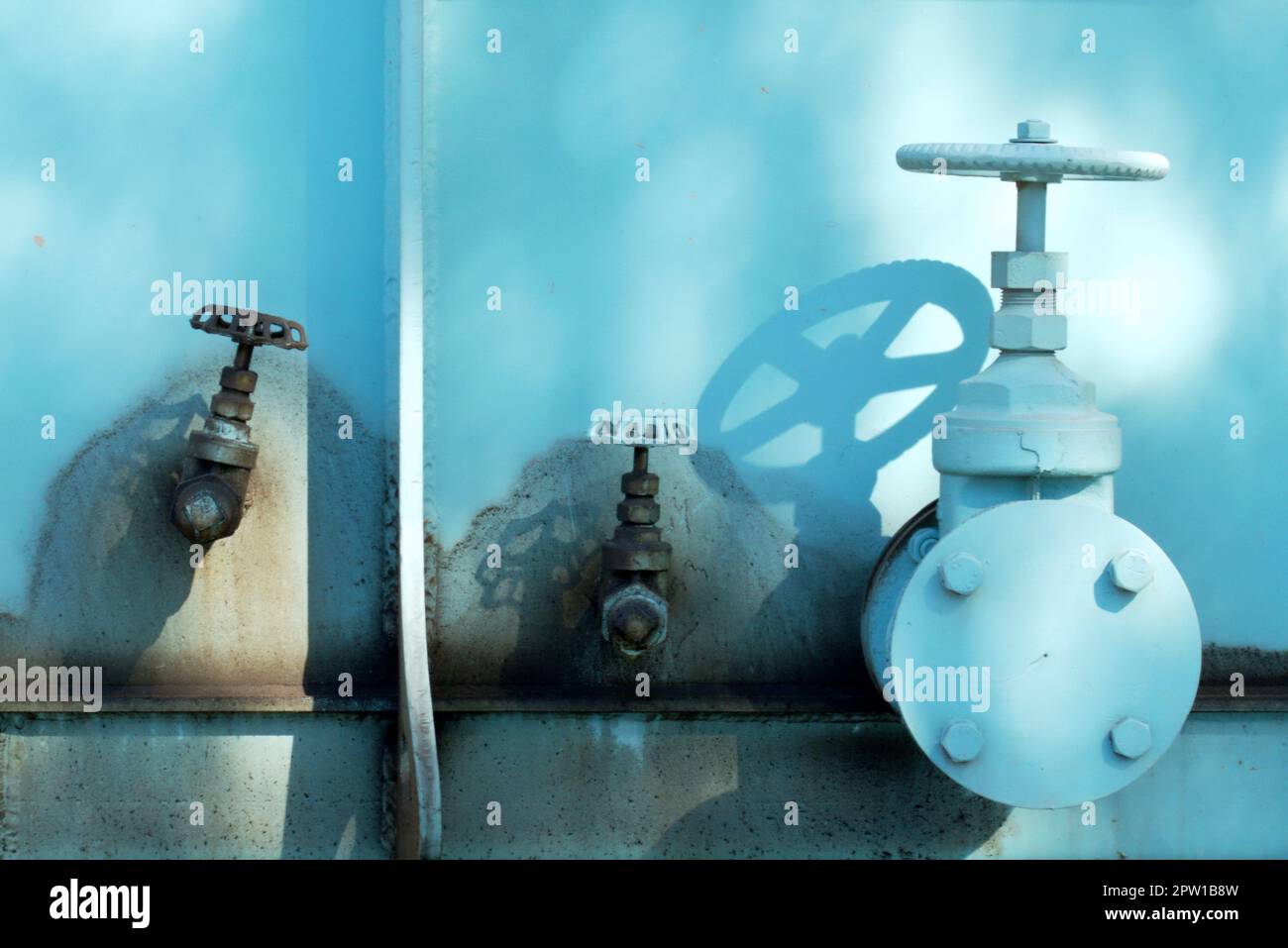 Turquoise painted industrial valves. Detail close up Stock Photo - Alamy