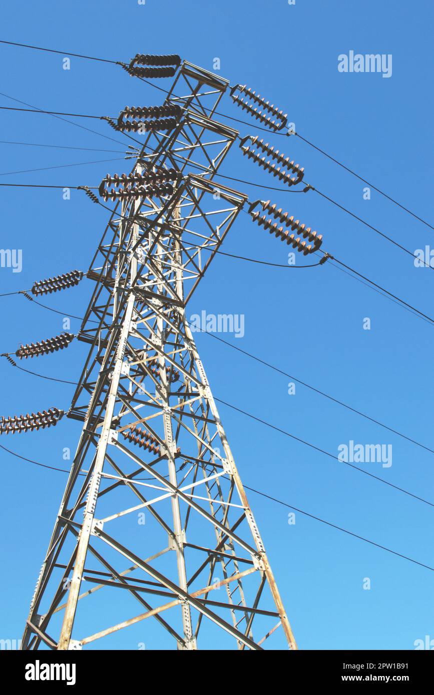 Steel frame electrical pylon. Low angle shot against a blue sky Stock ...