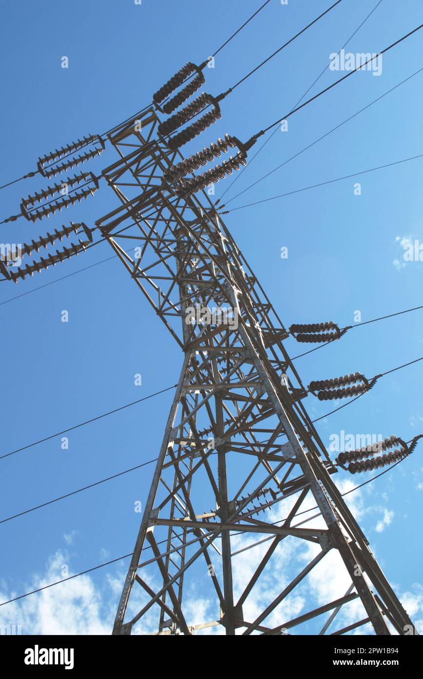 Steel frame electrical pylon. Low angle shot against a blue sky Stock ...